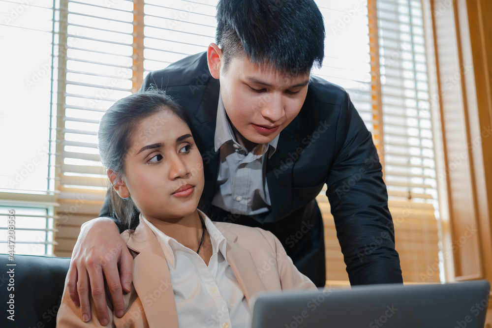 Unhappy asian young employee, employer colleague or boss touching at ...