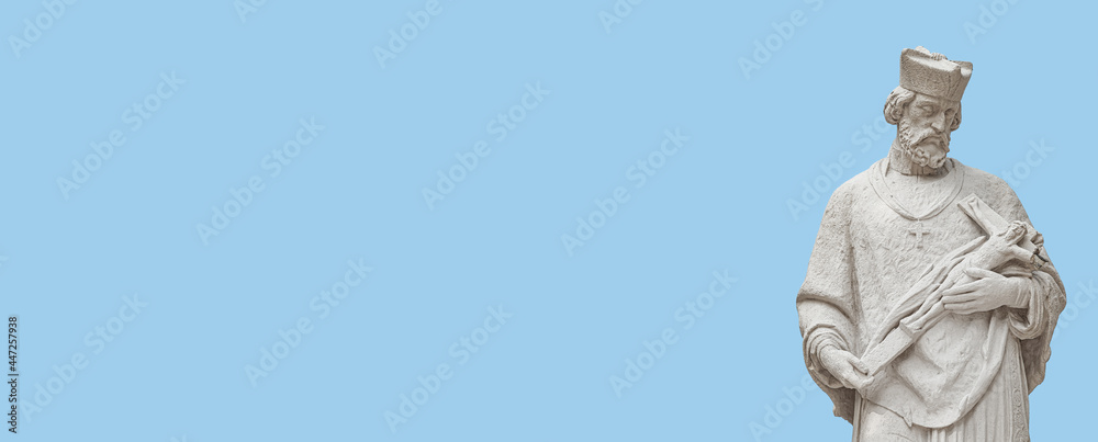 Banner with statue of a priest with figure of crucified Jesus in Vienna ...