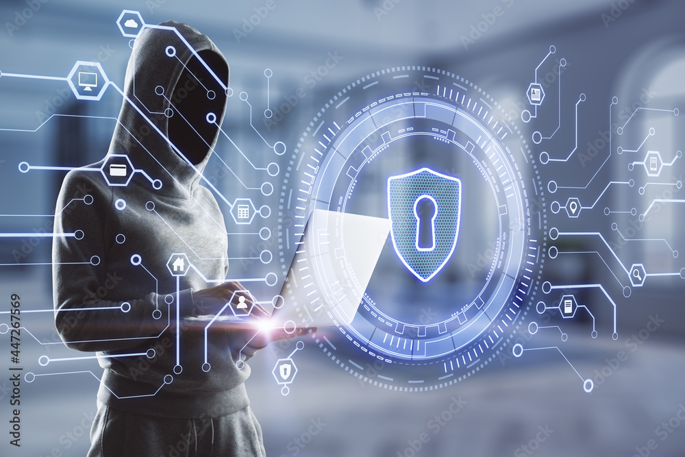 Hacker using laptop with creative glowing lock icon on blurry office ...