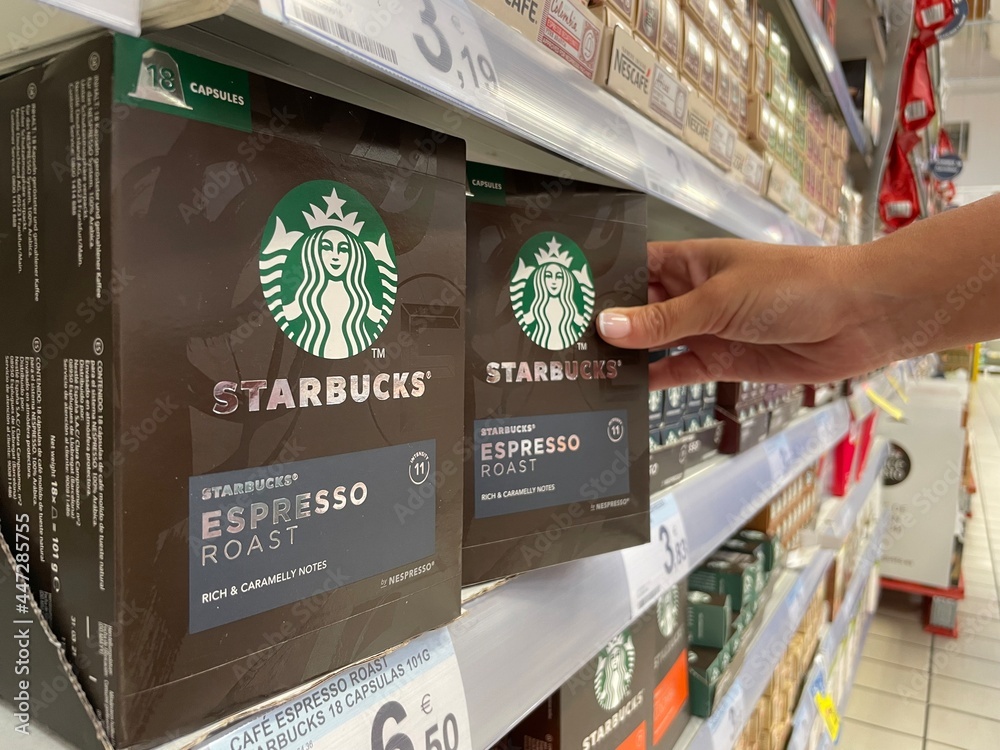 woman hands picking starbucks coffee from supermarket shelve Stock ...