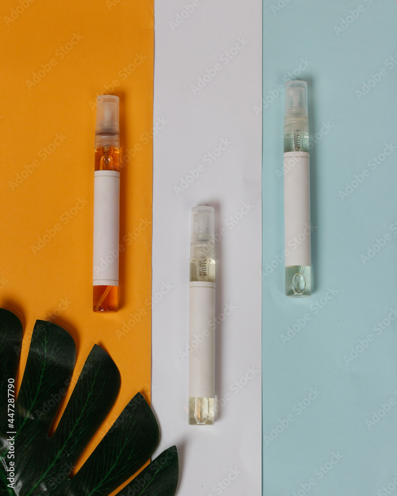 Plain perfume bottle packaging isolated on a rainbow background. Plain ...