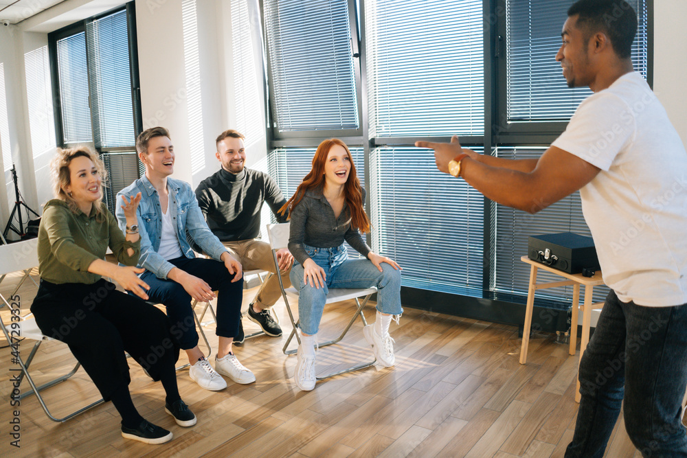 Group of young diverse multiethnic colleagues playing in active games ...