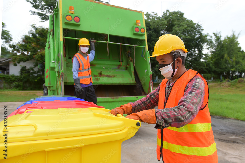 garbage collector Two garbagemen working together on emptying dustbins ...