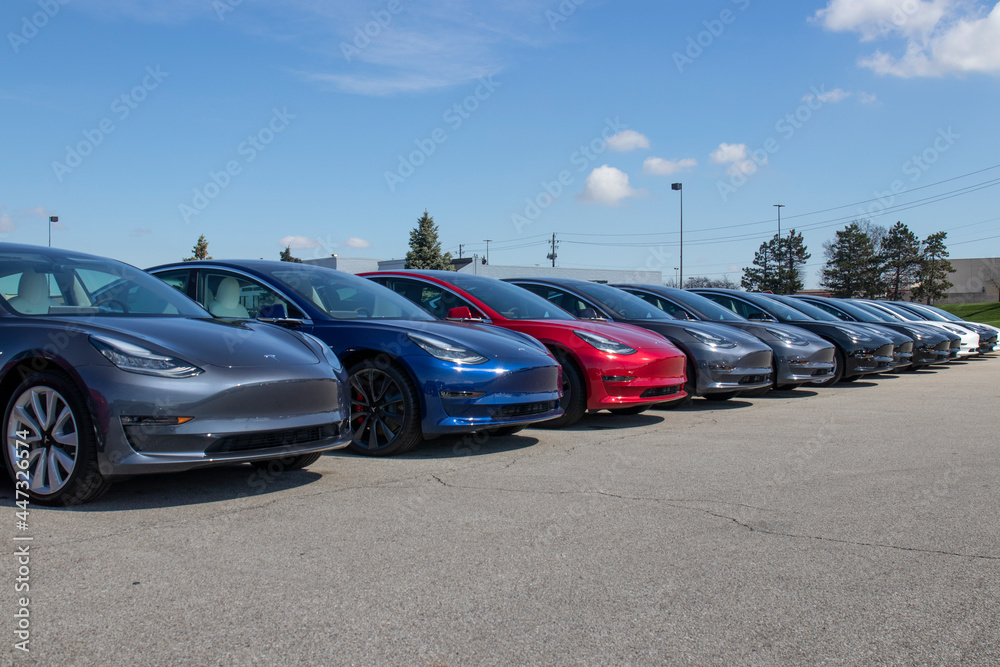 Tesla electric vehicles awaiting preparation for sale. Tesla EV Model 3 ...
