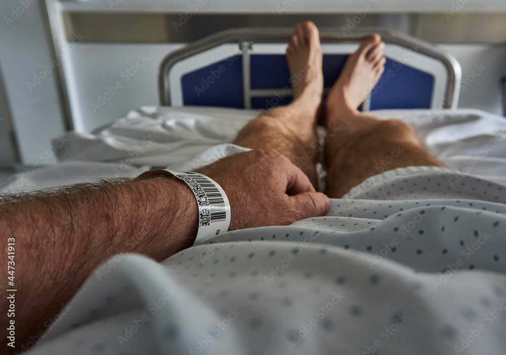 Patient code on the wrist of a patient in hospital bed Stock Photo ...