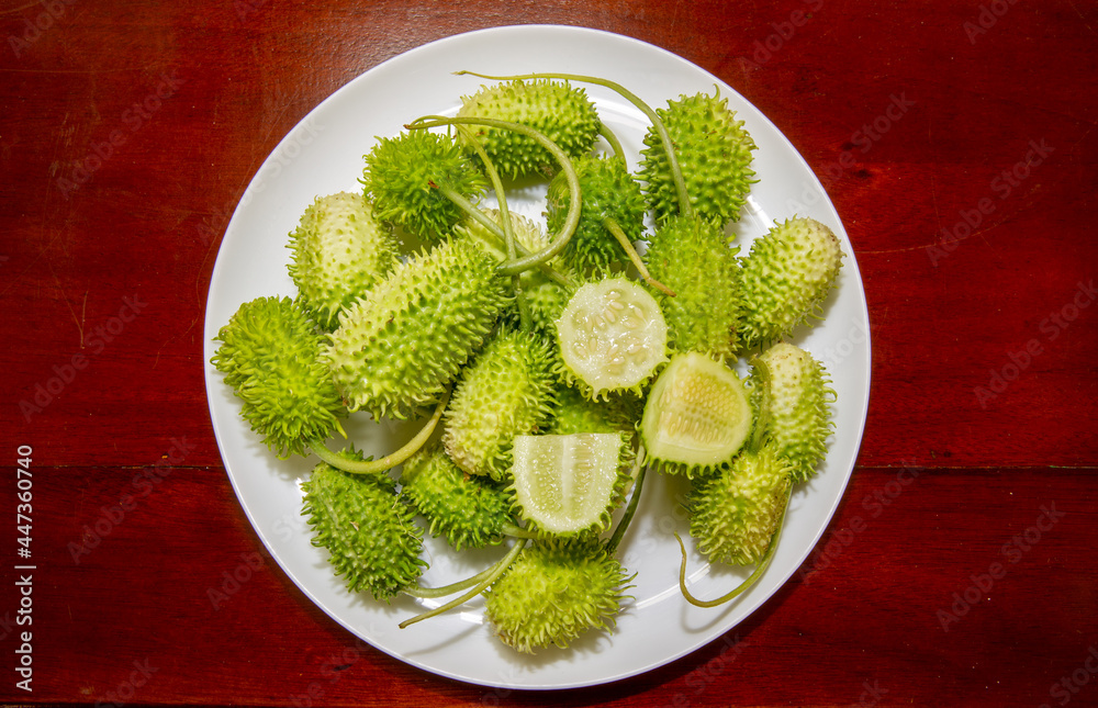 Gherkin, maxixe (Cucumis anguria), green fruits, whole and in cut, with ...