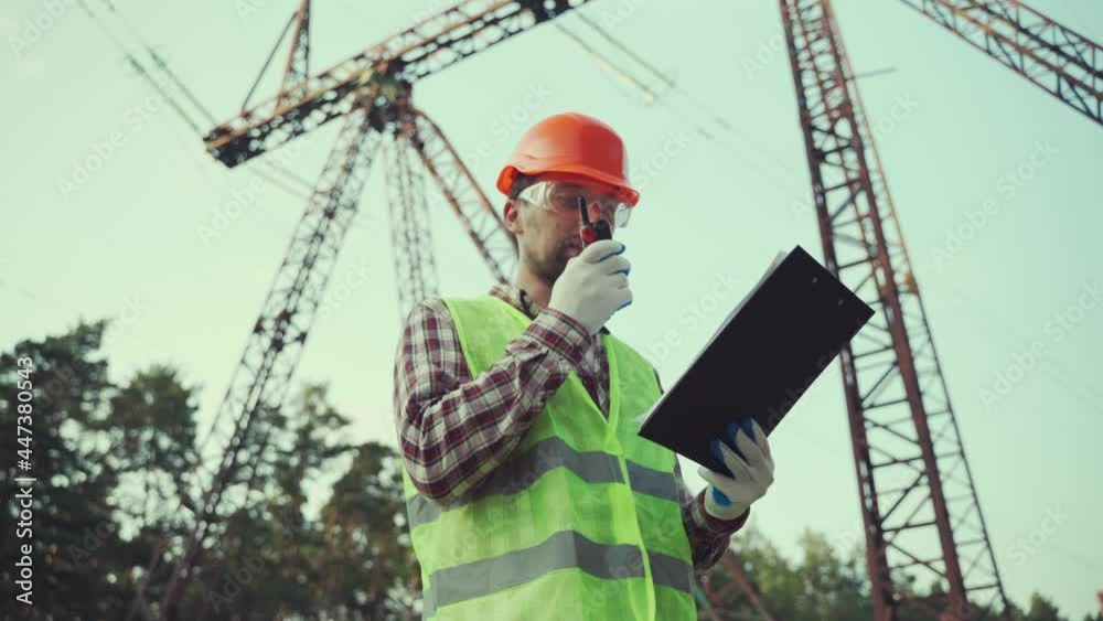 Video Stock Electrical equipment worker near high voltage tower using ...