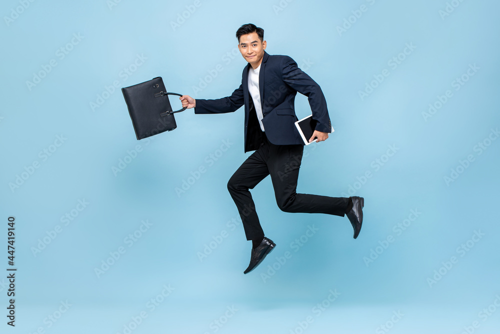 Full length portrait of happy young handsome Asian male office worker ...