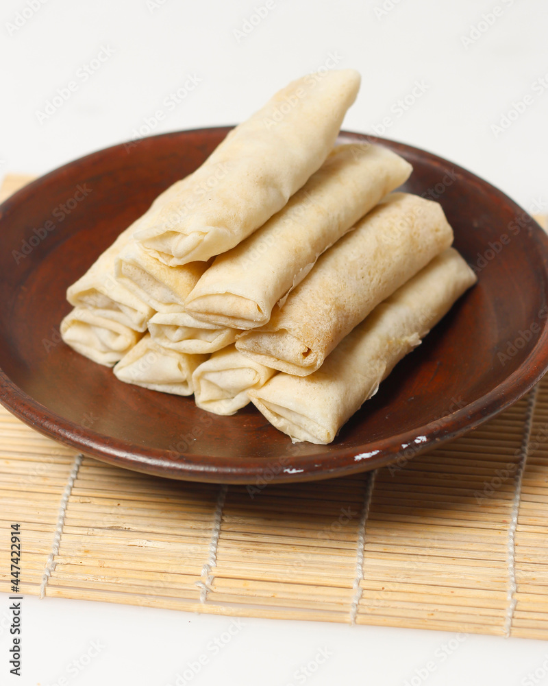 Spring roll cake isolated on white background. Lumpia is a typical ...