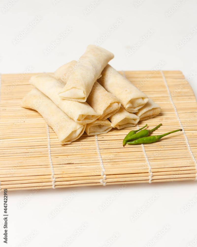 Spring roll cake isolated on white background. Lumpia is a typical ...