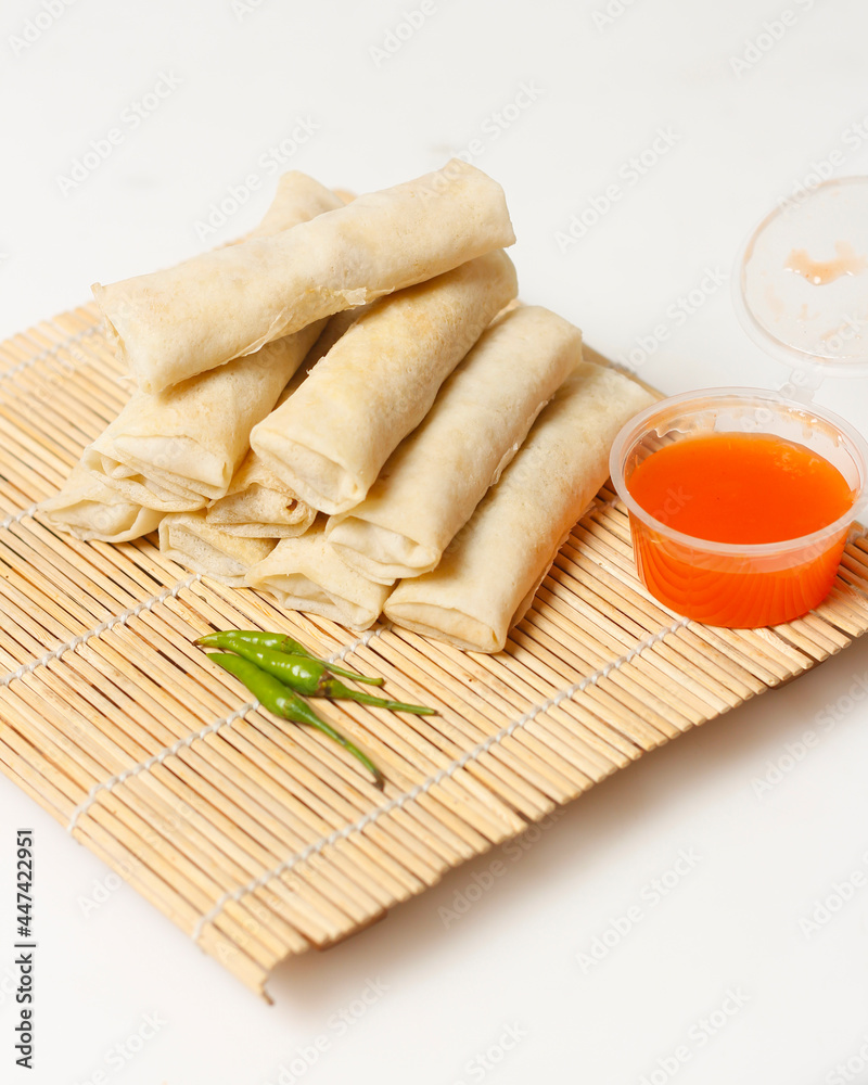 Spring roll cake isolated on white background. Lumpia is a typical ...