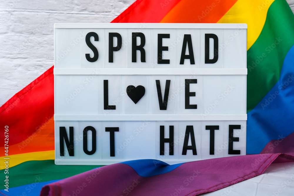 Rainbow flag with lightbox and text SPREAD LOVE NOT HATE. Rainbow lgbtq ...