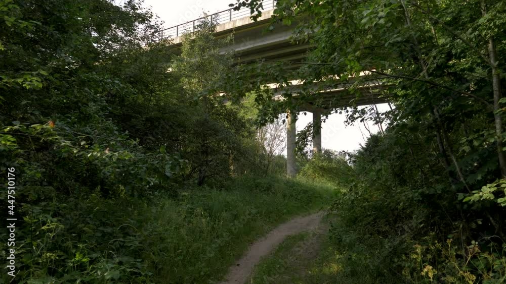 Walking slowly under abandoned highway bridge. The area under the ...
