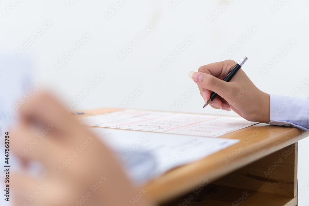 Student holding pencil writing learning Exams multiple-choice quizzes ...