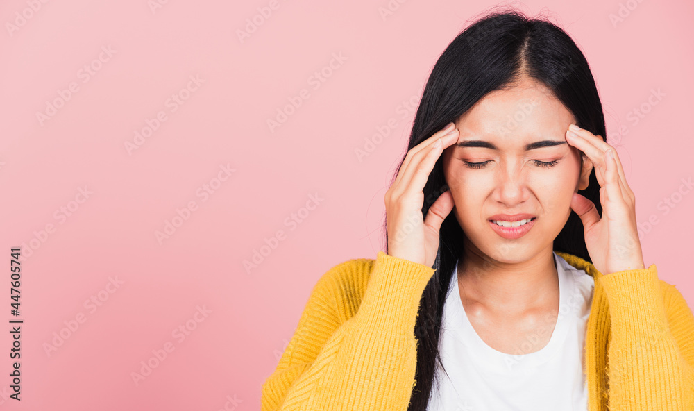 Portrait of beautiful Asian young woman sad tired strain face holding ...