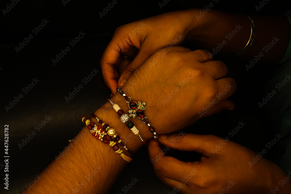 Sister tying rakhi thread on brother's hand Raksha Bandhan special ...