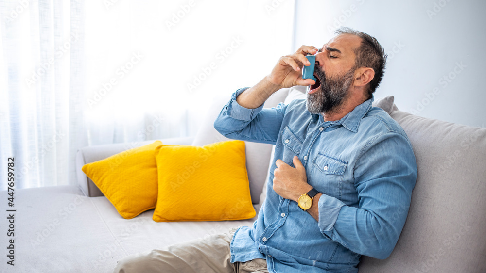 Portrait of a man with an asthma inhaler in his hands, an asthmatic ...