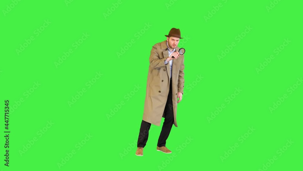 Retro detective looking through magnifying glass for evidence on crime ...