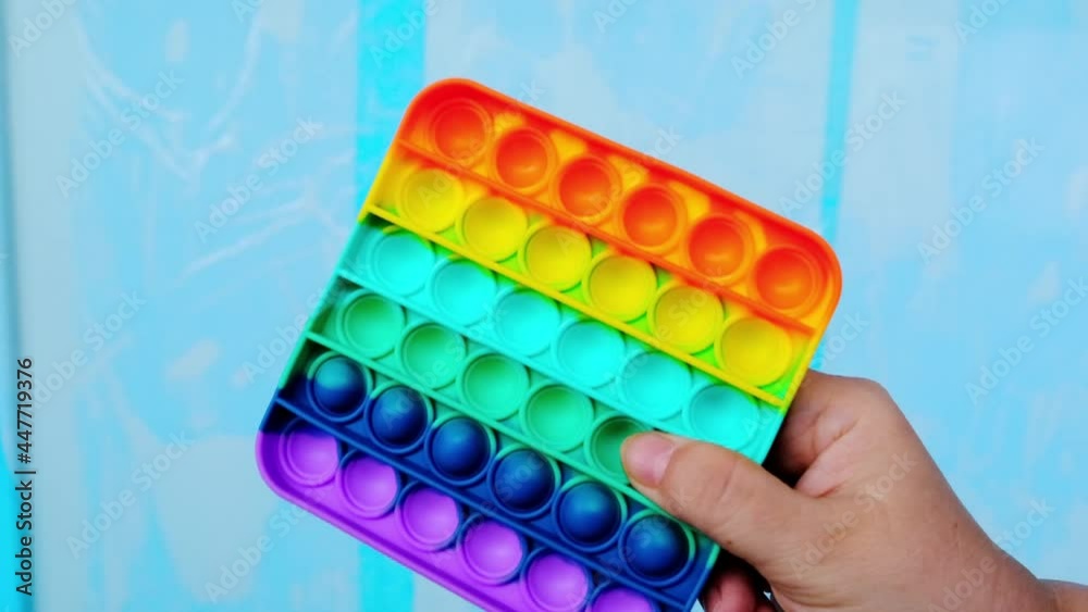 female hand holding a rainbow Toy antistress Pop it, poppit -new fidget ...