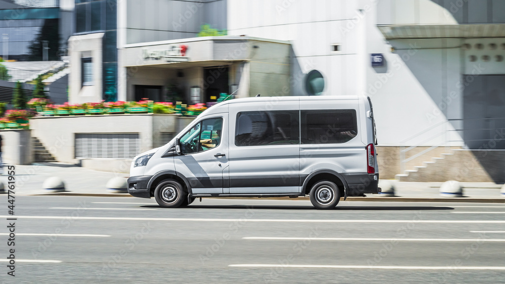Ford Transit speeding on road. White passenger Ford Transit van in ...