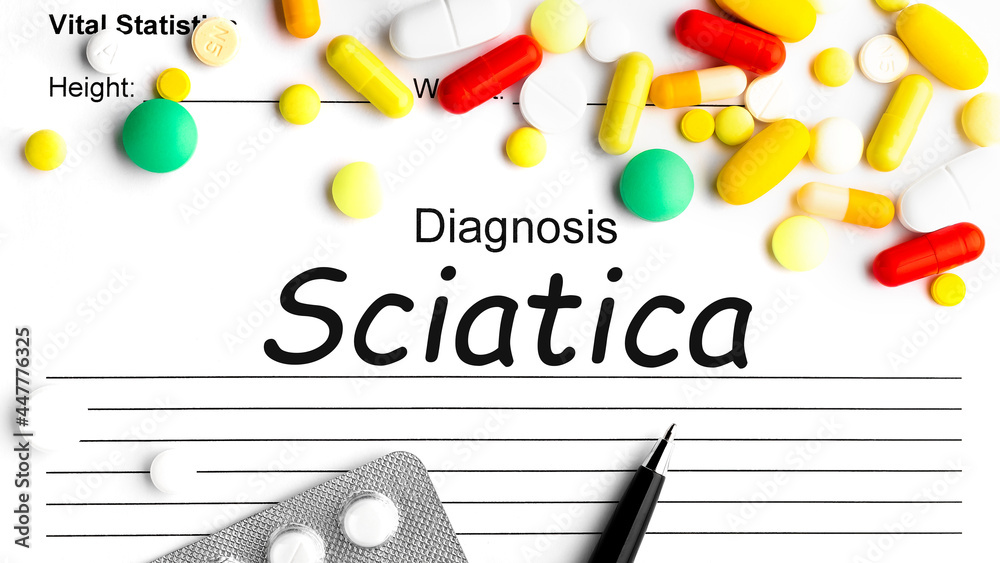 Word SCIATICA on paper, assorted pharmaceutical medicine pills, tablets ...