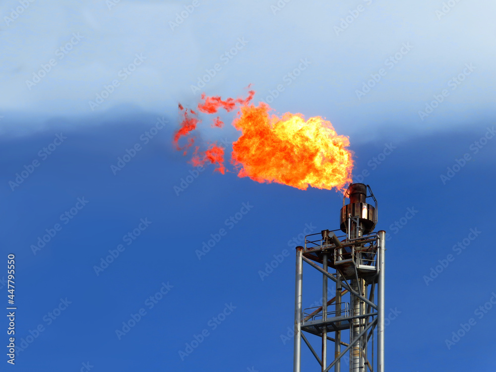 Gas flare is releasing and burning to the atmosphere at an offshore gas ...