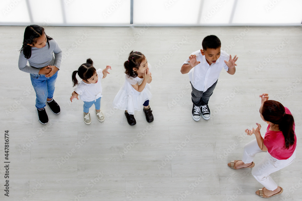 Top view shot of Asian female primary education school dancing teacher ...