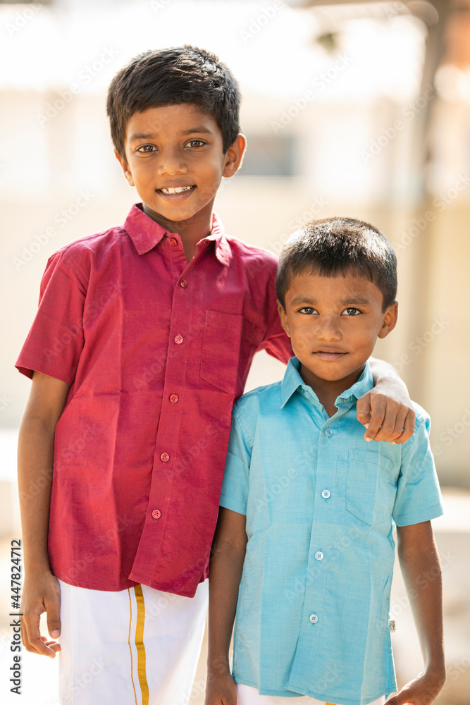 Cute Indian little brothers posing in traditional dress at outdoor ...