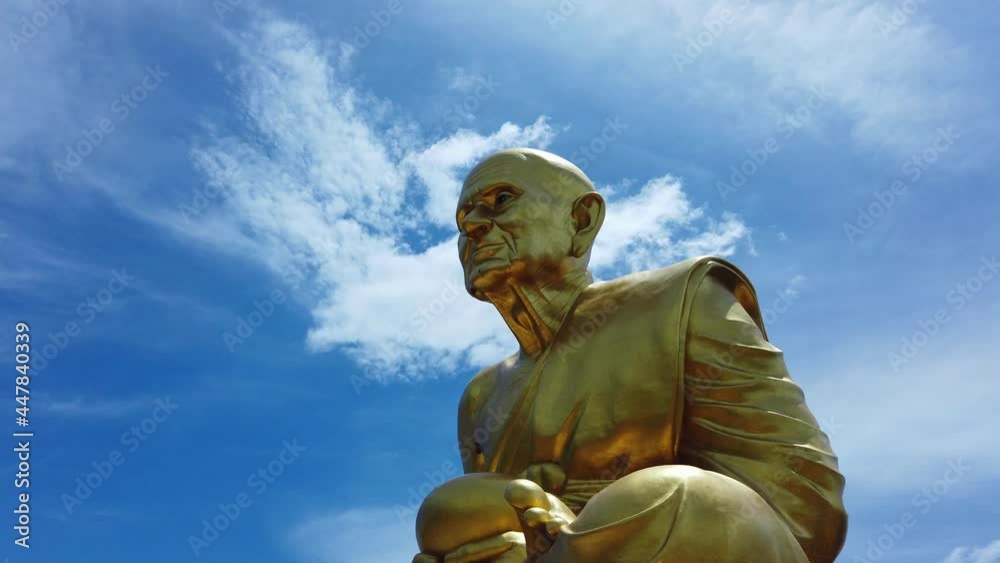 Gigantic golden statue of a Buddhist monk Luang Pu Thuat against ...
