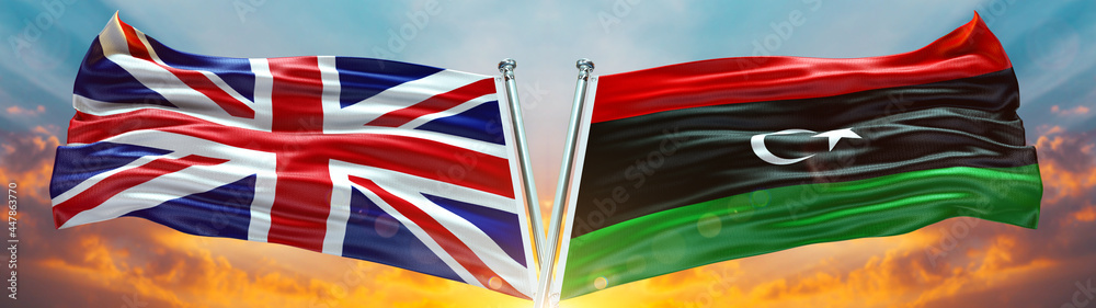United Kingdom Flag and Libya flag waving with texture sky Cloud and ...