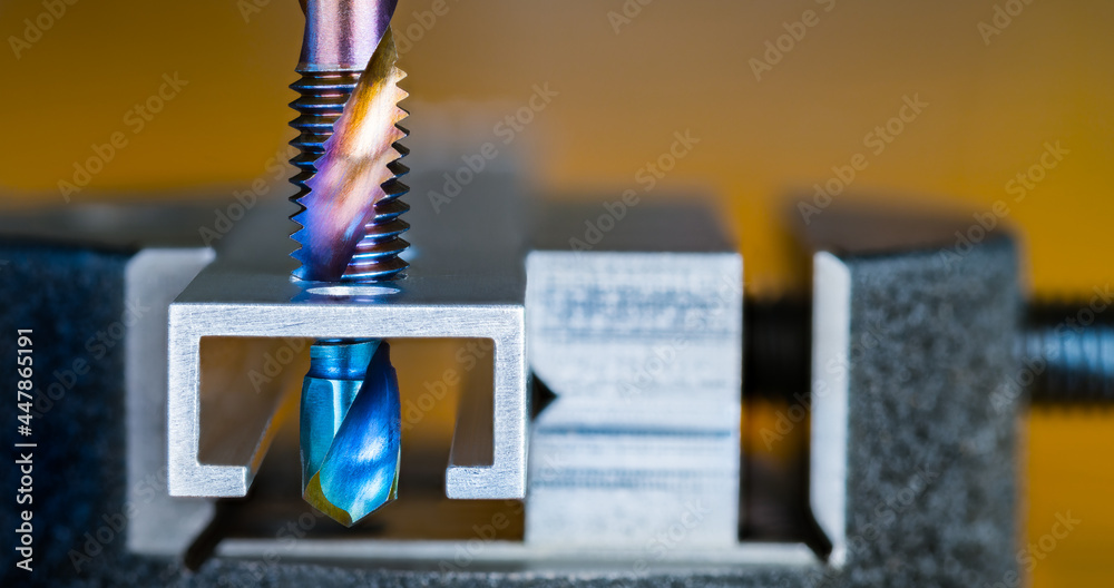 Steel tap and drill bit with blue purple nano titanium coating on a ...