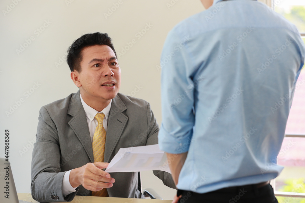 Asian businessman manager in suit holding paperwork and blaming for ...