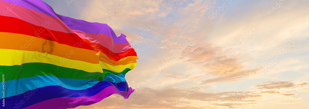 nine-stripe pride flag waving in the wind at cloudy sky. Freedom and ...