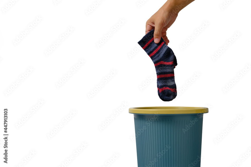 Man hand throws an old sock into trash on white background of isolate ...