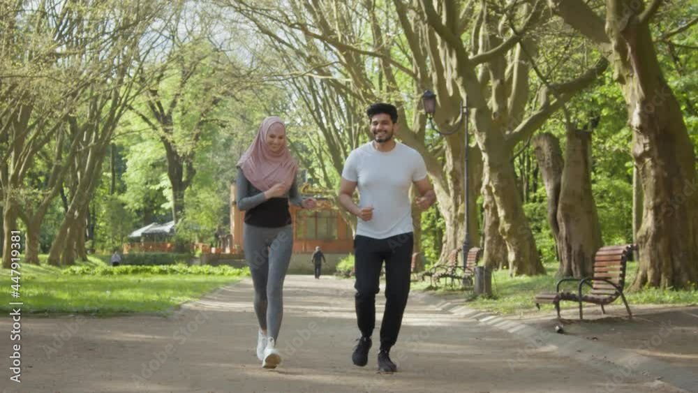 Muslim man and woman run. Happy arabian couple in activewear jogging at ...