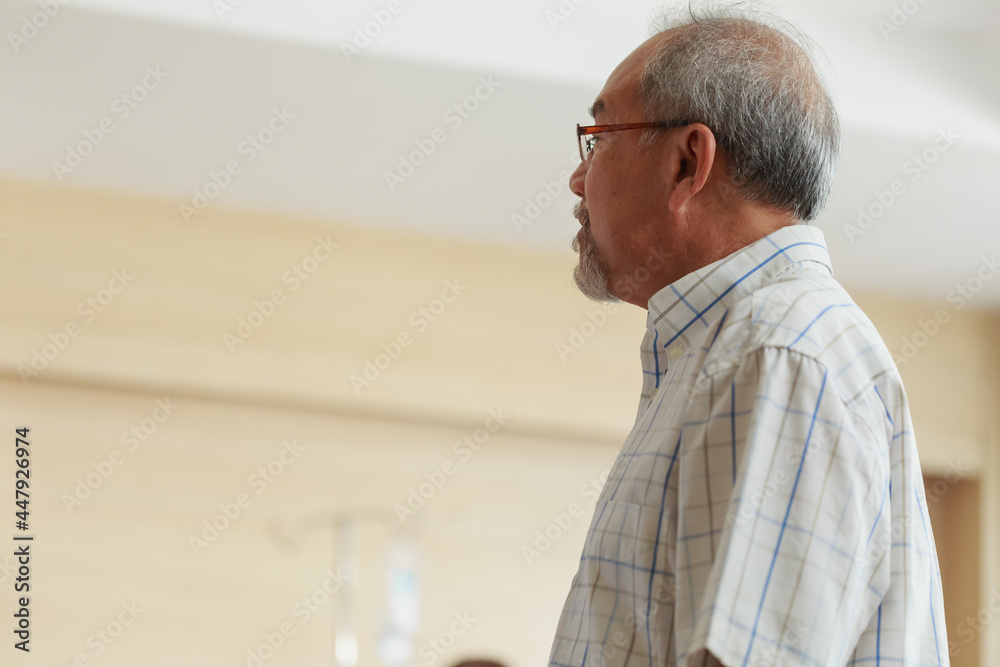 Asian measure man with grey hair look at his kid laying on the hospital ...