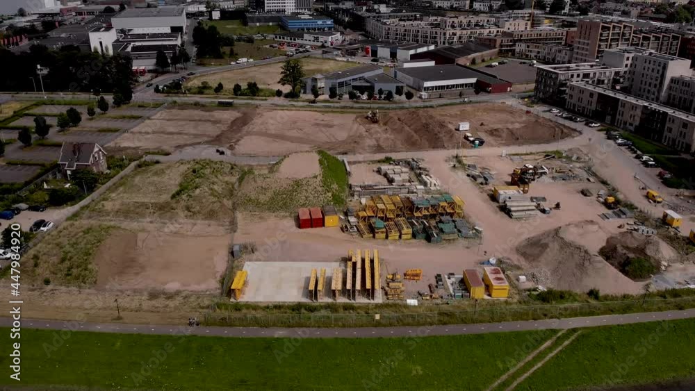 Construction site at riverbank of river IJssel. Ascending aerial ...