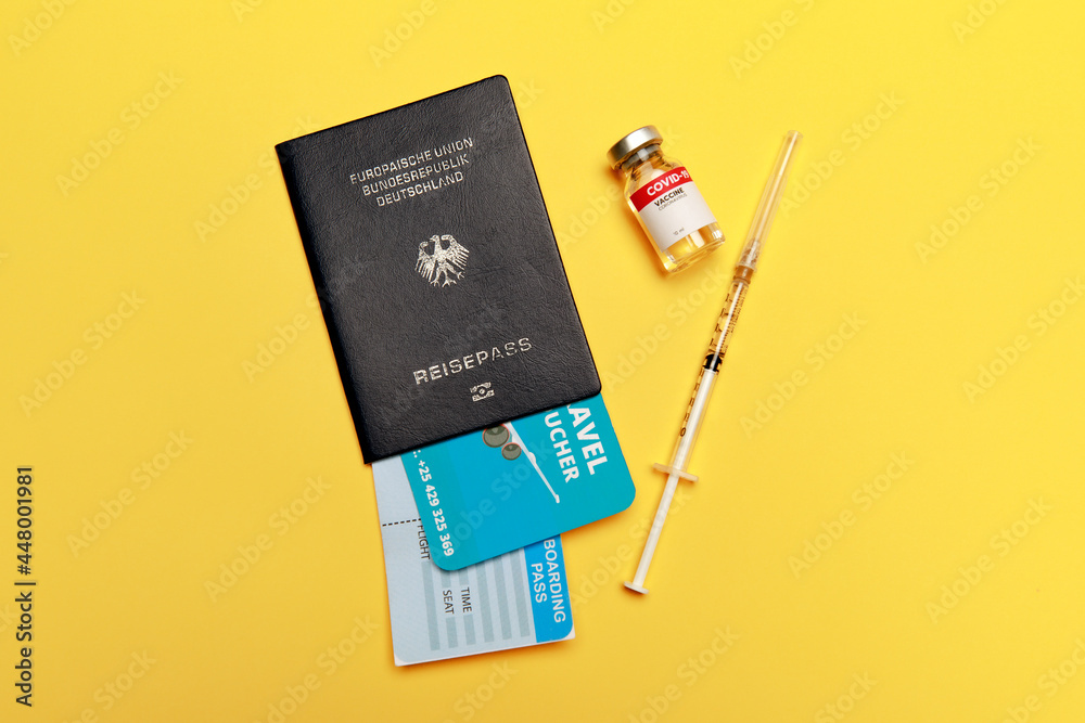 Flight boarding pass and passport beside recommended covid-19 vaccine ...