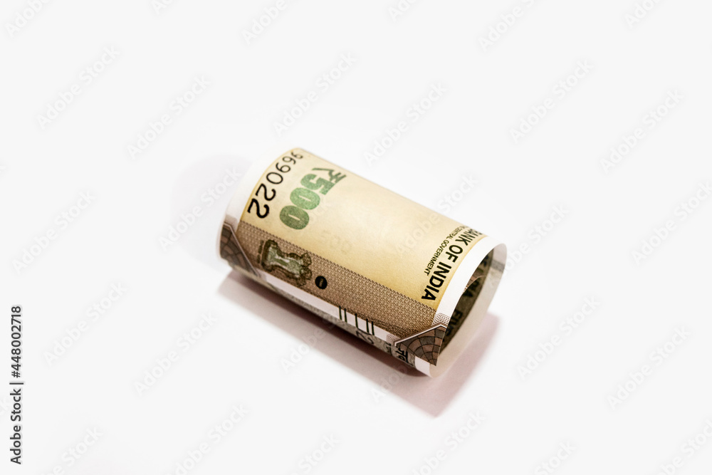 Indian five thousand rupees rolled up banknote isolated on white ...