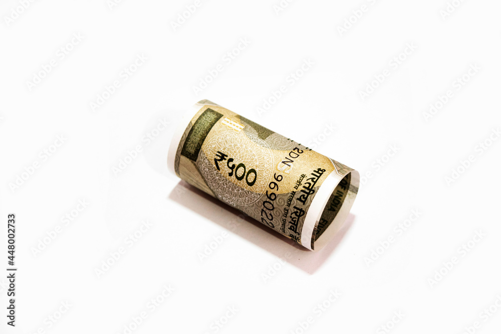 Indian five thousand rupees rolled up banknote isolated on white ...