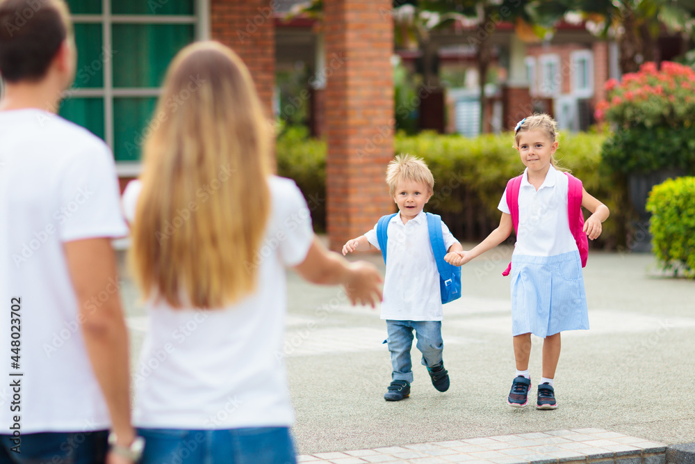School pick up. Mother and kids after school. Stock Photo | Adobe Stock