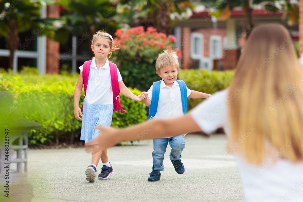 School pick up. Mother and kids after school. Stock Photo | Adobe Stock