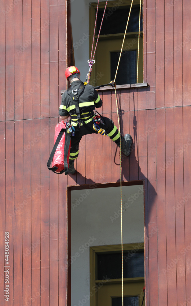 climber Firefighter during a training who enters from the window of the ...