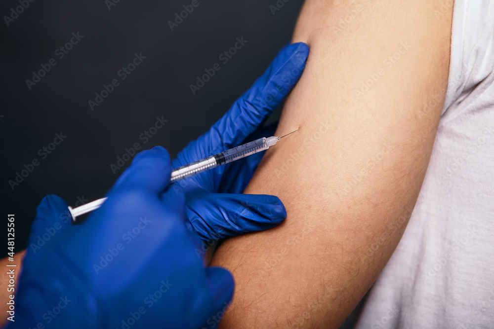 Man got a dose of the covid vaccine intramuscular. Nurse doctor ...