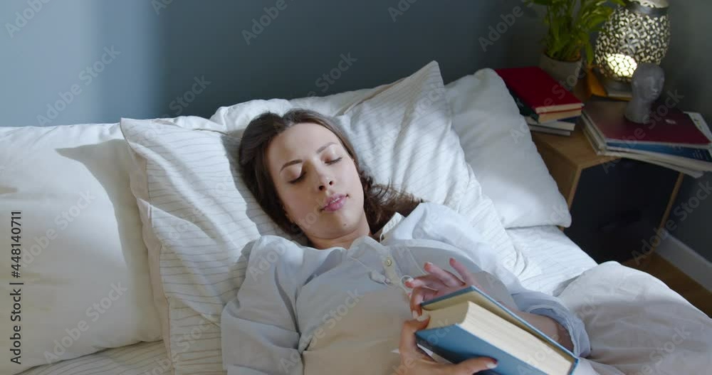 Beautiful Caucasian young woman laying in bed awake after long late ...