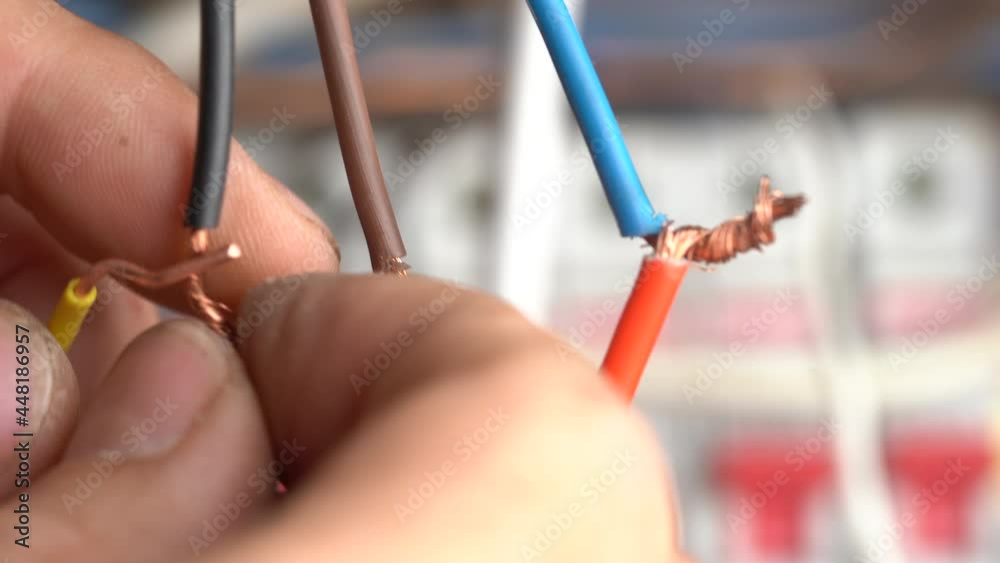 Male electrician connects electrical wires at home, close up. Very ...
