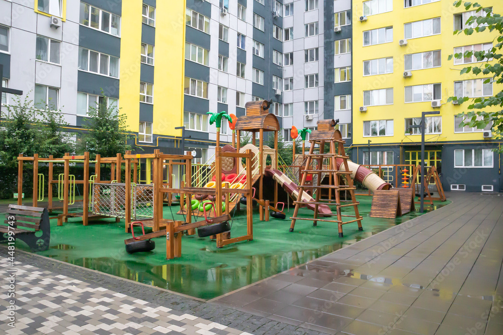 A courtyard of high-rise buildings with a modern and large playground ...