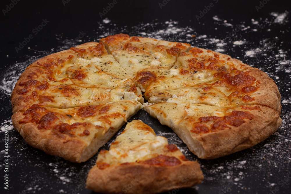 Delicious slices cheese pizza with flour, tomatoes and olive oil on ...