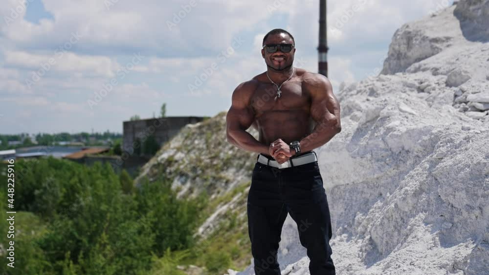Shirtless afro american sportsman outdoors. Muscular bodybuilder with ...