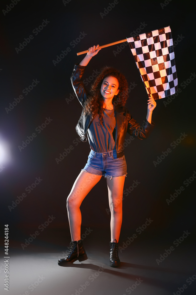 Beautiful young woman with racing flag on dark background Stock Photo ...